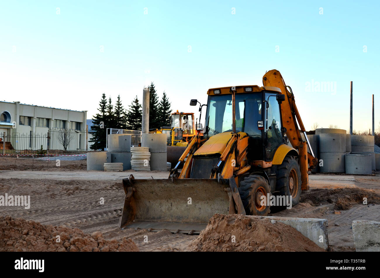 Wheel tractor excavator loader with bucket at construction works in ...