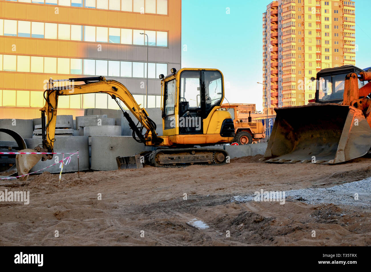 Mini excavator on a construction site, on a street reconstruction Stock ...