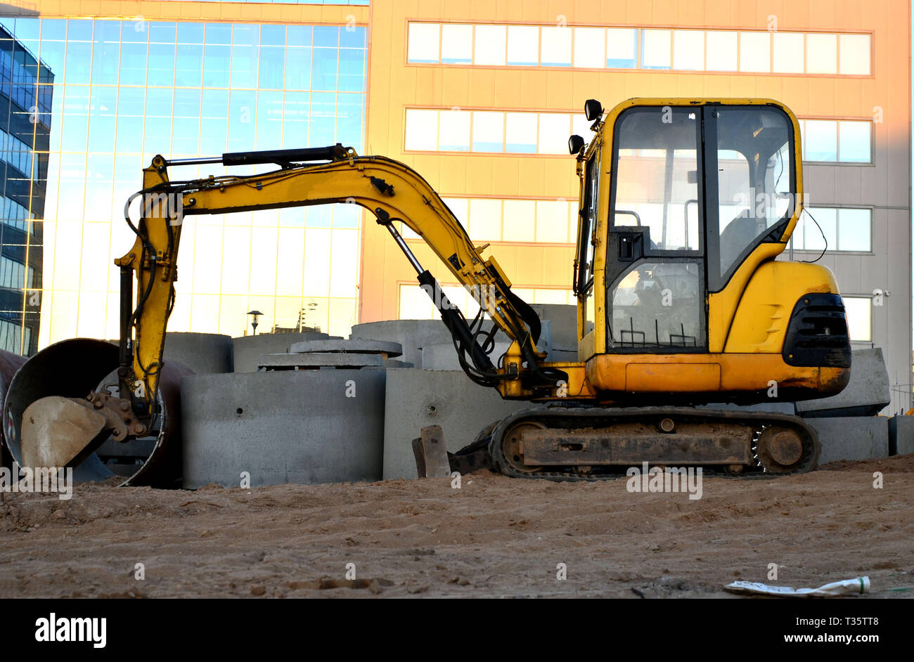 Mini excavator on a construction site, on a street reconstruction Stock ...