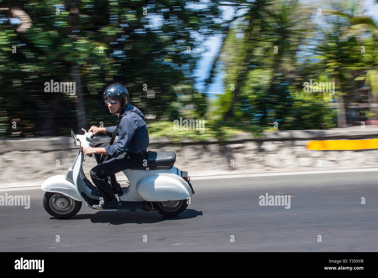 young Italian man rides vespa scooter on coast road in Sorrento Italy ...