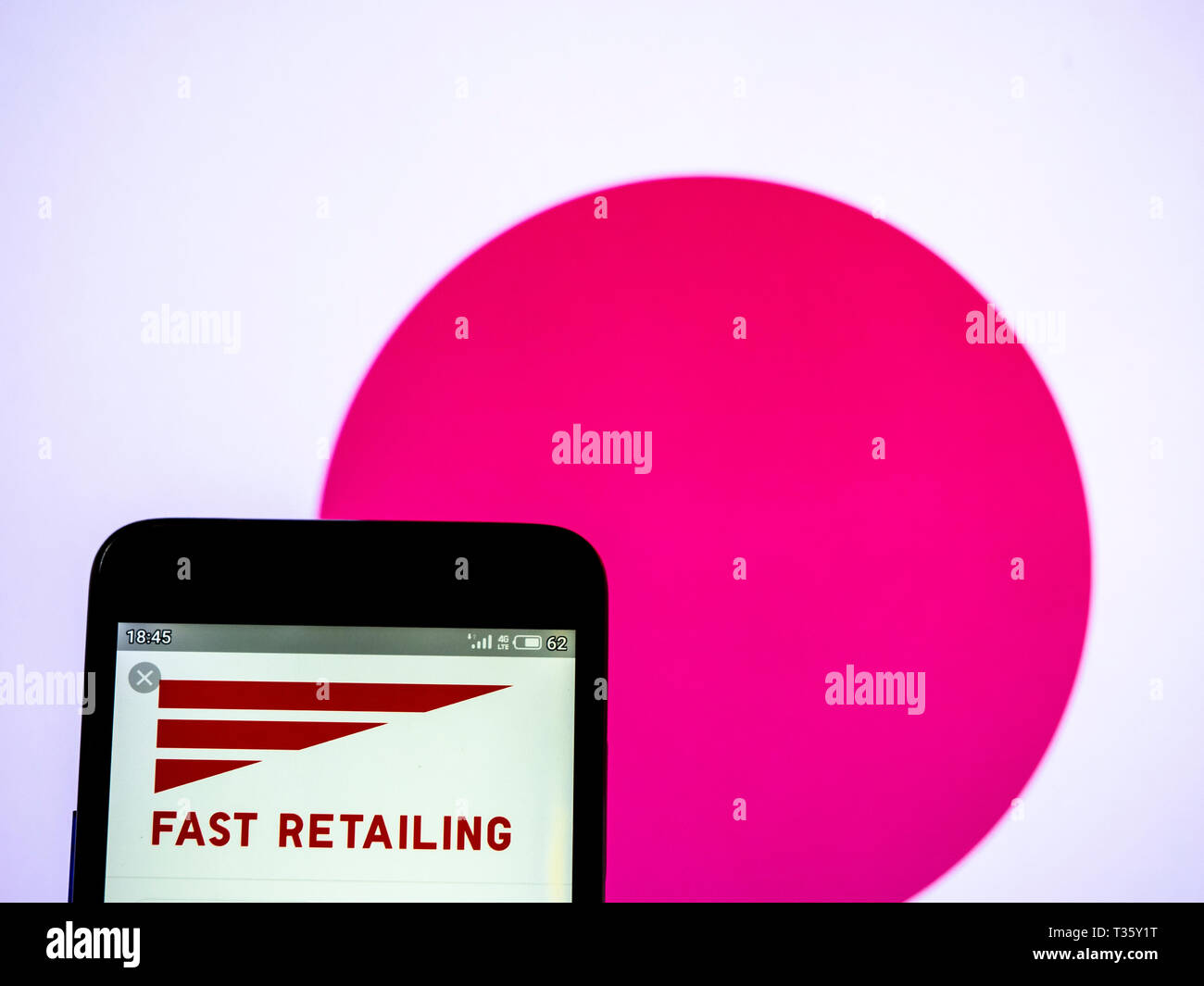 In this photo illustration a Fast Retailing Co, Ltd logo seen displayed ...