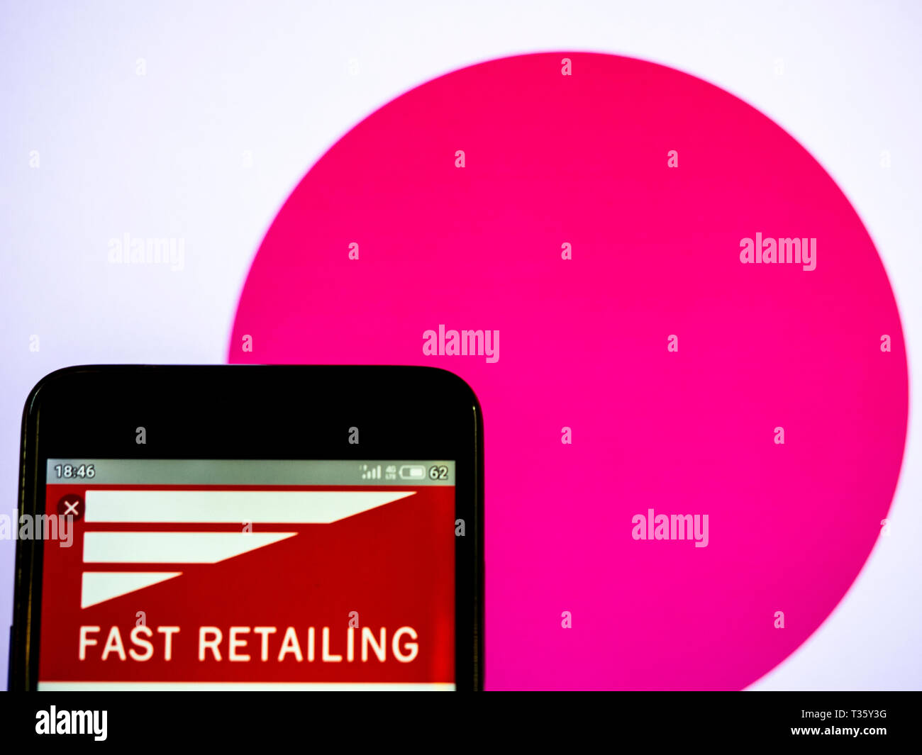 In this photo illustration a Fast Retailing Co, Ltd logo seen displayed on a smart phone Stock ...