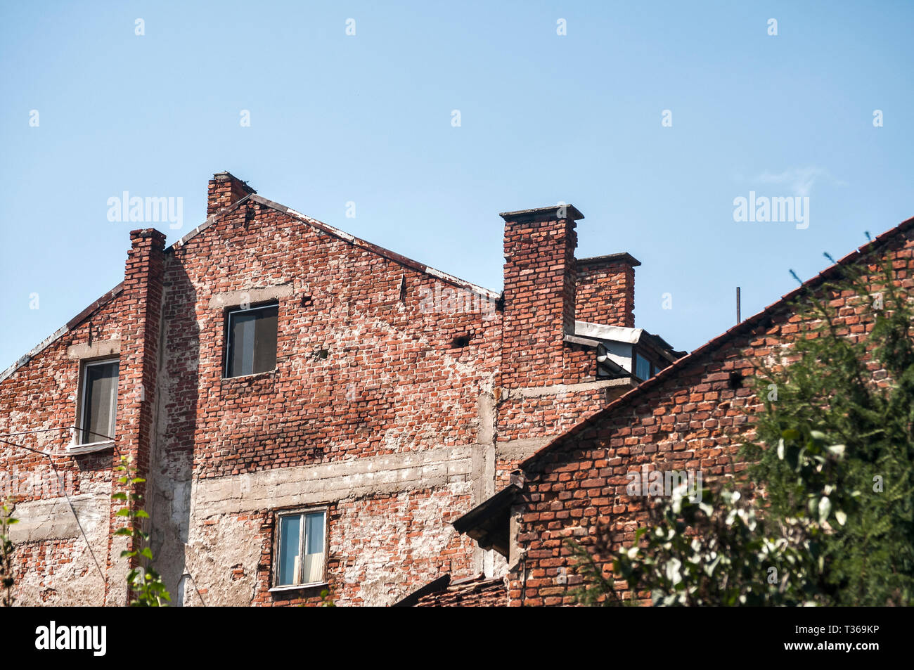 Old vintage grunge backside brick wall urban houses Stock Photo - Alamy
