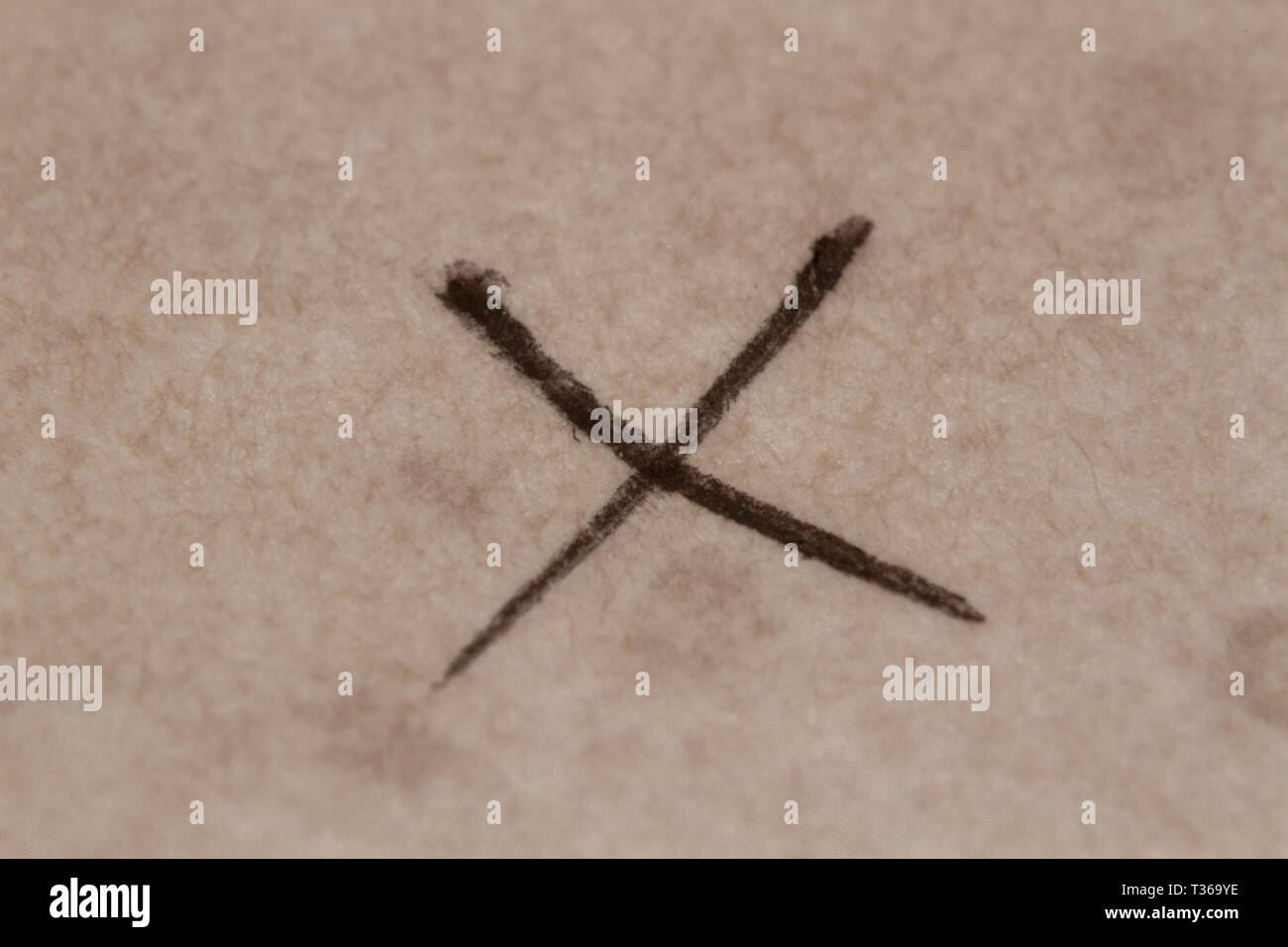 Cross mark handwriting on the old paper Stock Photo - Alamy