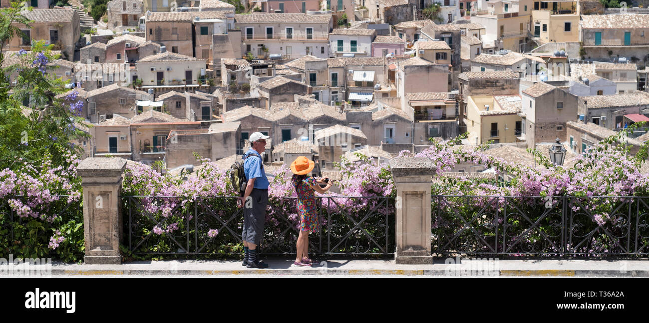 Tourists taking souvenir photographs using traditional camera in ...