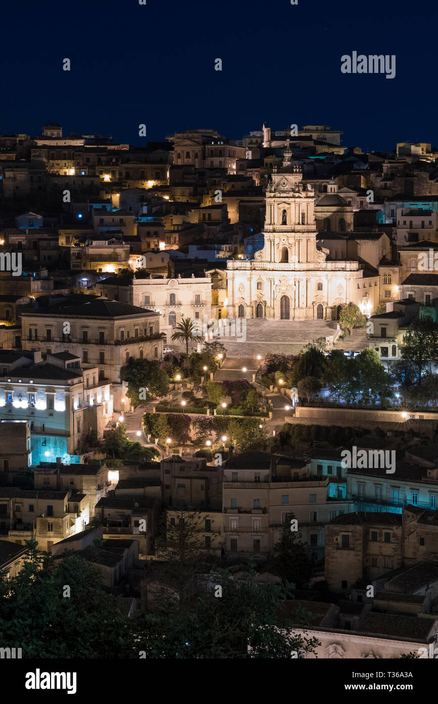 Floodlit buildings in ancient hill city of Modica Alta famous for its ...