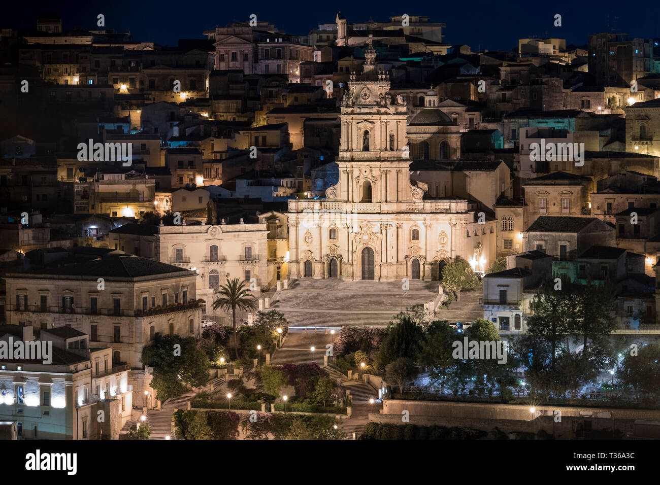 Floodlit buildings in ancient hill city of Modica Alta famous for its ...