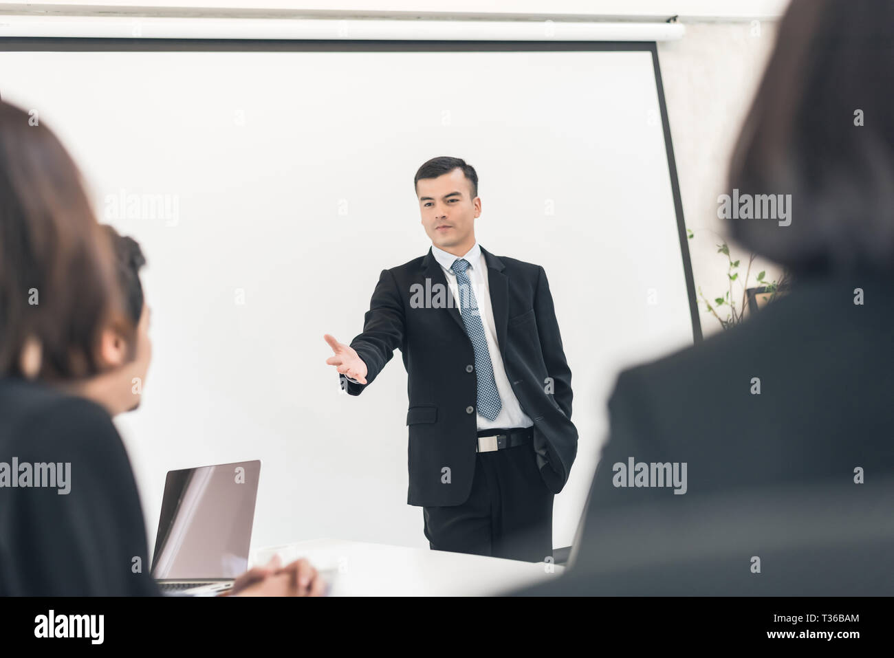 asian business man introduce at the meeting Stock Photo - Alamy