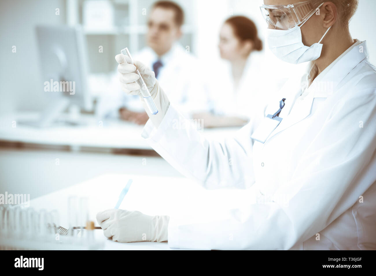 Scientific research team with clear solution in laboratory Stock Photo ...