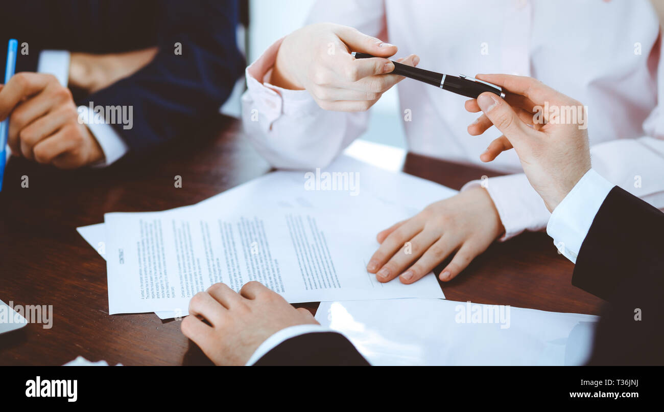 Business women giving a pen to businessman for contract signing ...