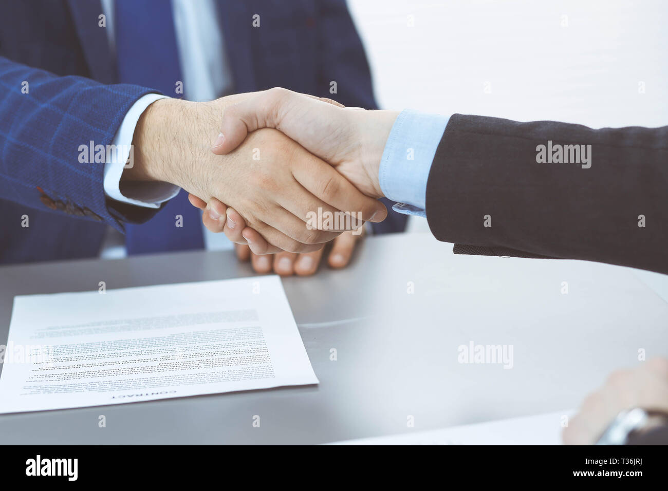 Men at a table signing papers hi-res stock photography and images - Alamy