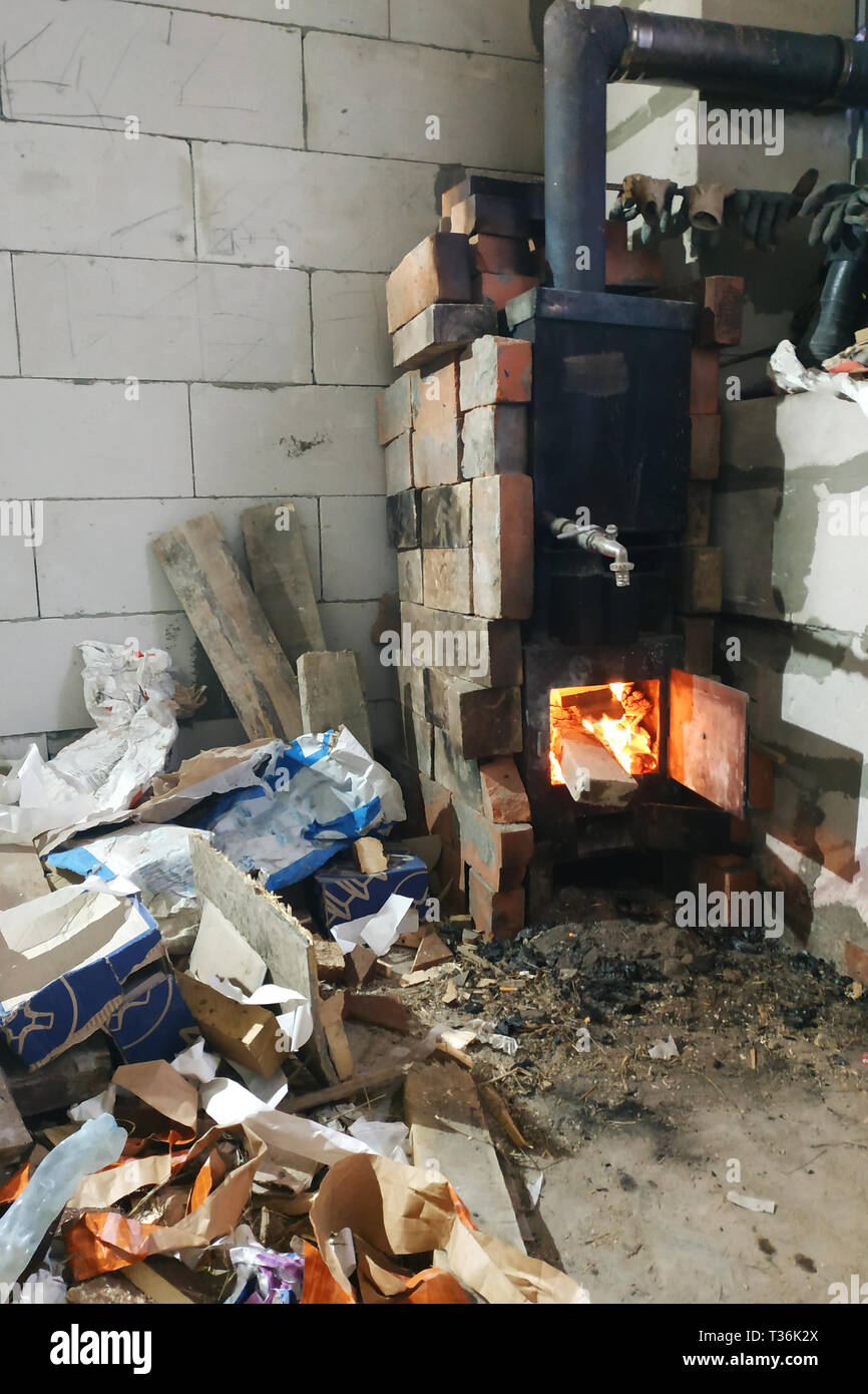 The wood burning stove burns with open doors in violation of poses a ...