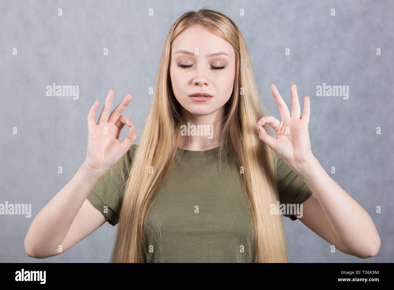 Young beautiful woman shows ok sign. Body language concept Stock Photo ...