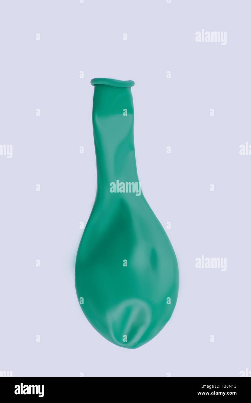 Deflated green balloon isolated on white. Green airless balloon ...
