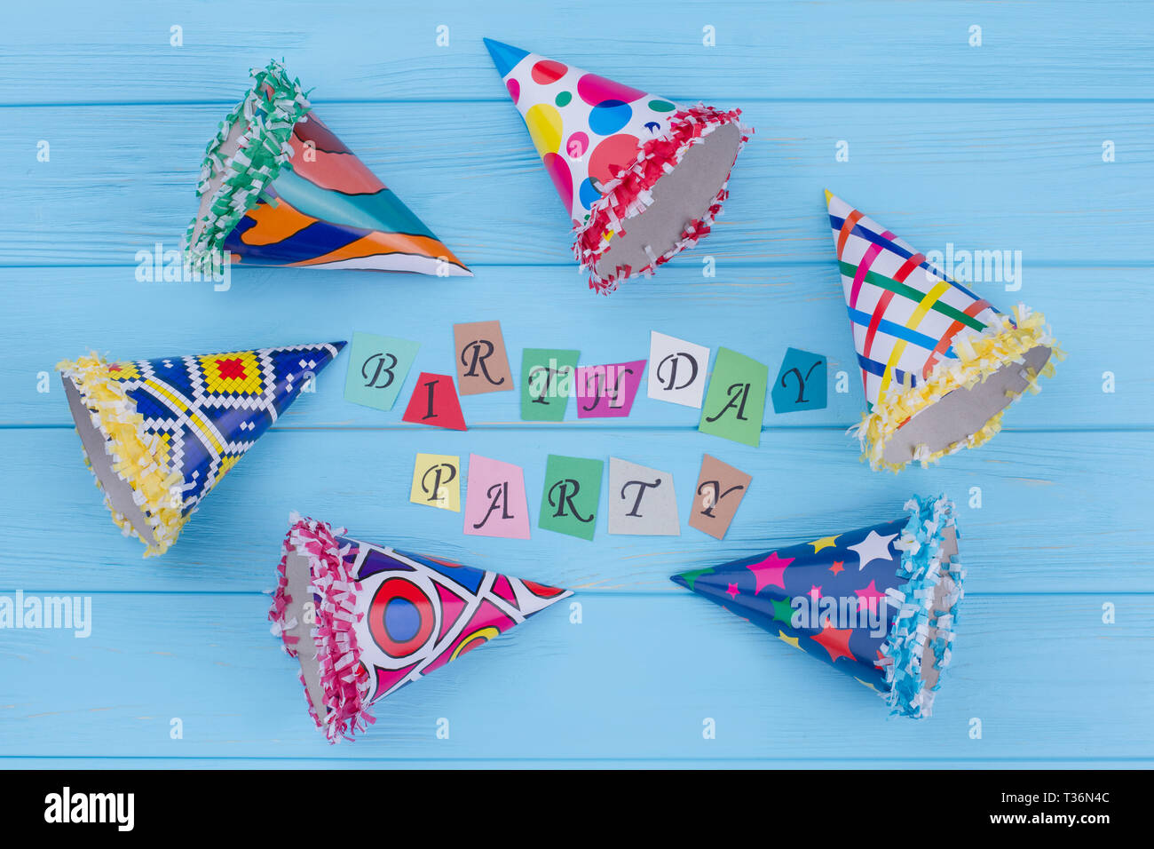 Birthday party composition with cardboard hats. Flat lay colorful party ...