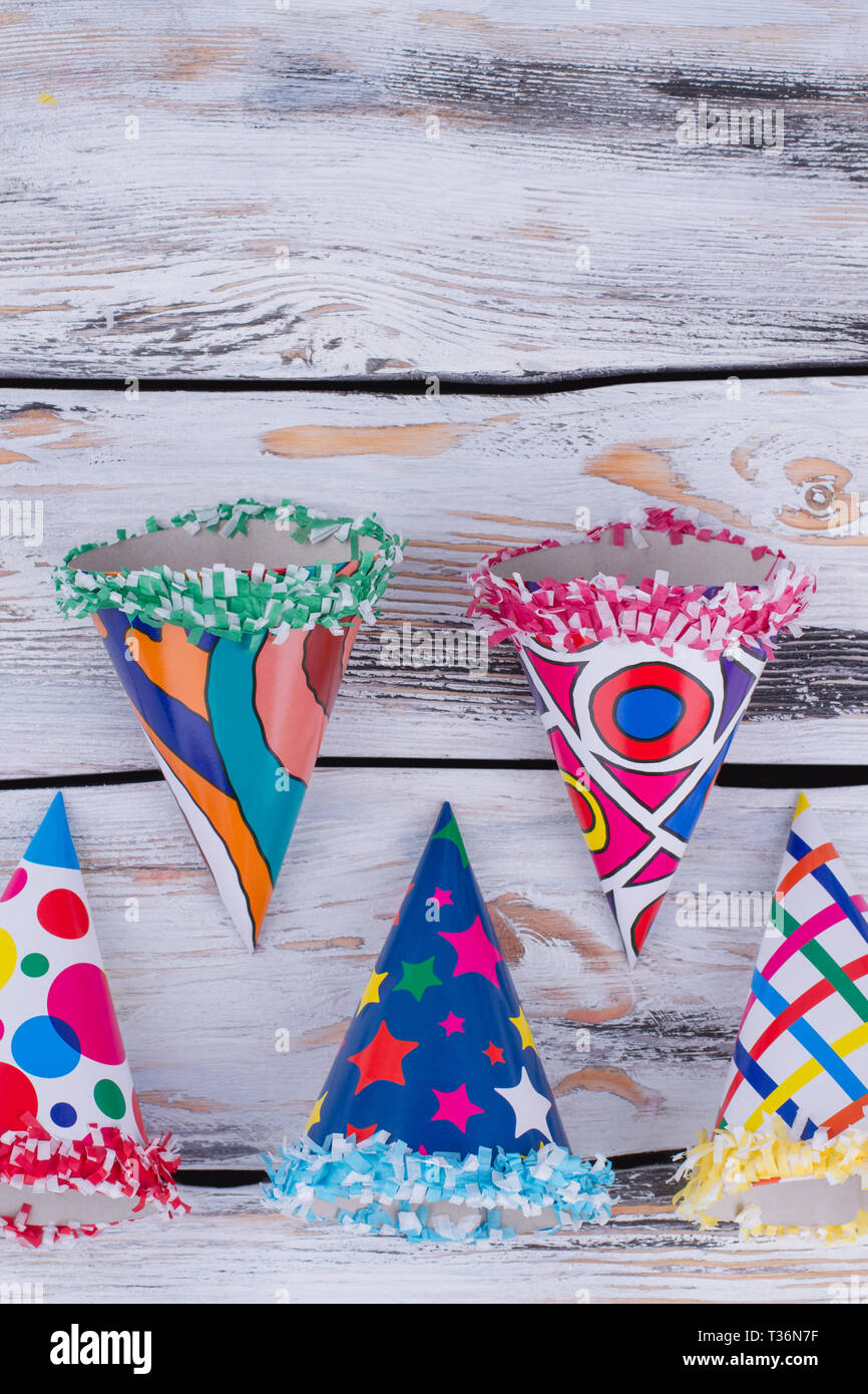 Birthday paper caps, top view. Decorated party caps on wooden ...