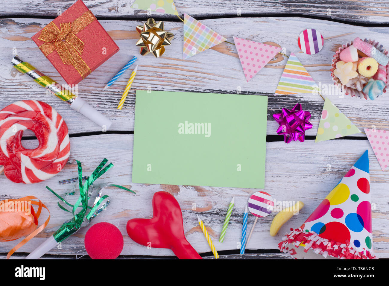 Blank paper card and Birthday decorations. Flat lay composition with ...