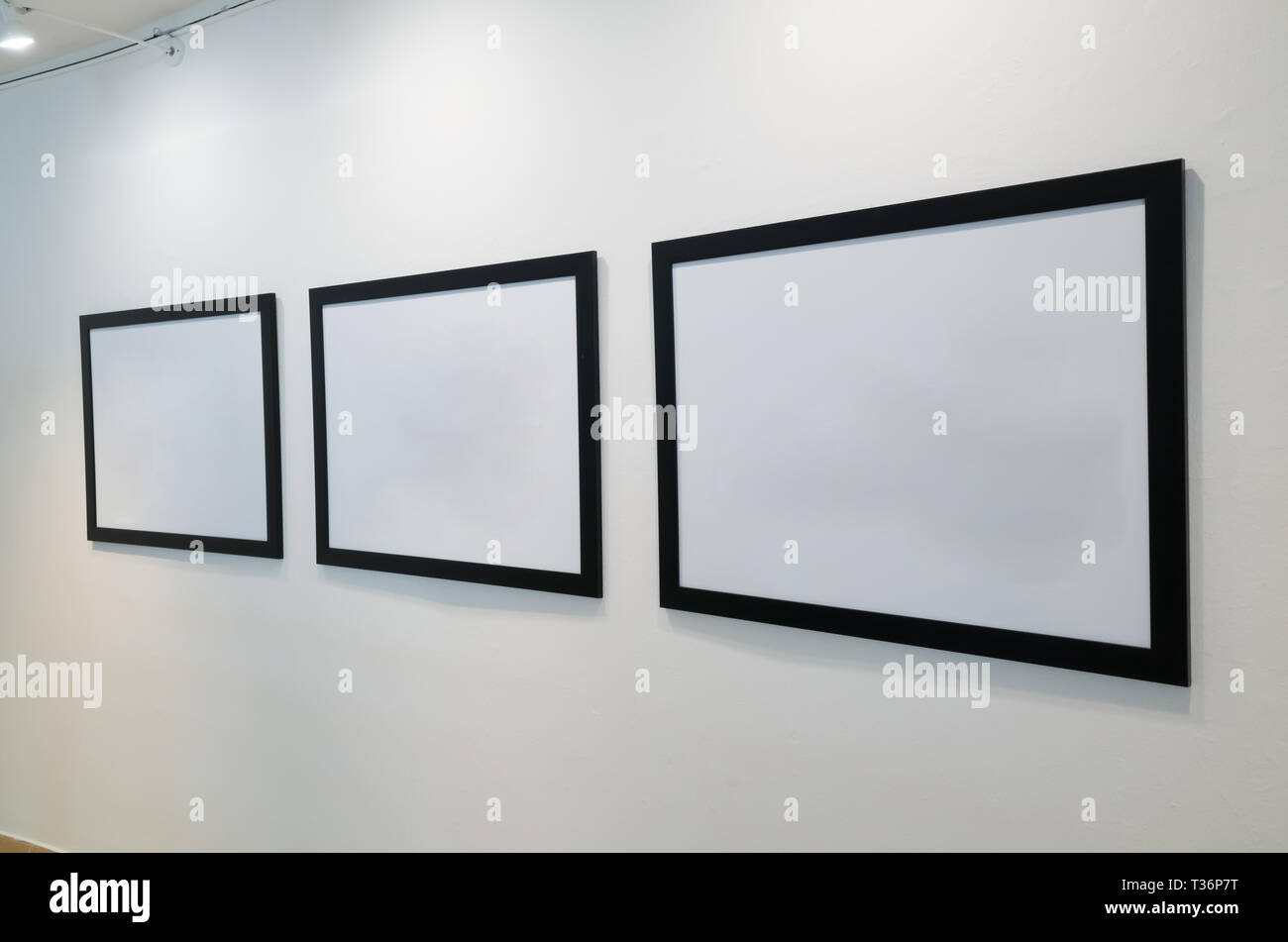 blank white picture frame on wall with nobody Stock Photo - Alamy