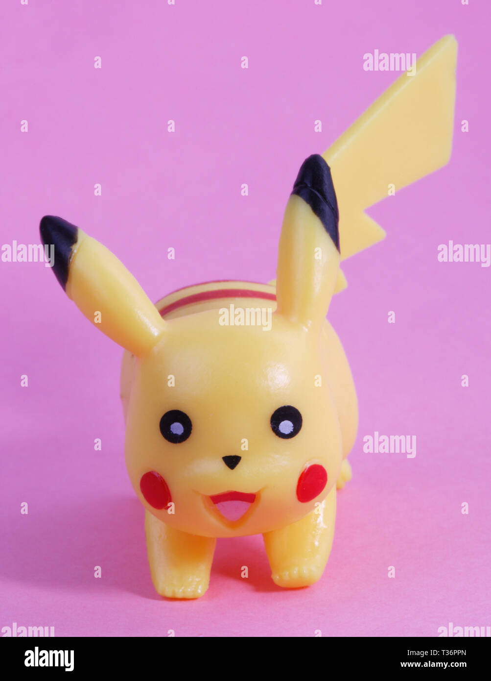 plastic toy on pink background Stock Photo - Alamy