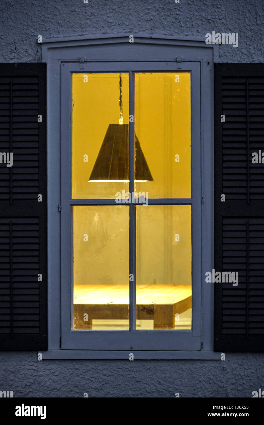 House at night with lit window Stock Photo - Alamy