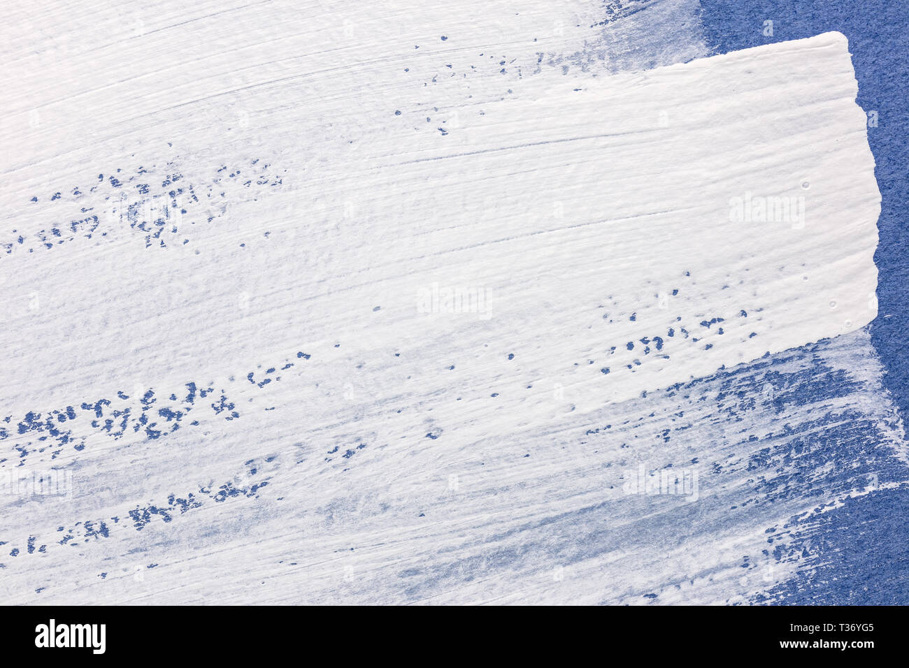 blue paper background hand painted with acrylic white color. brush ...