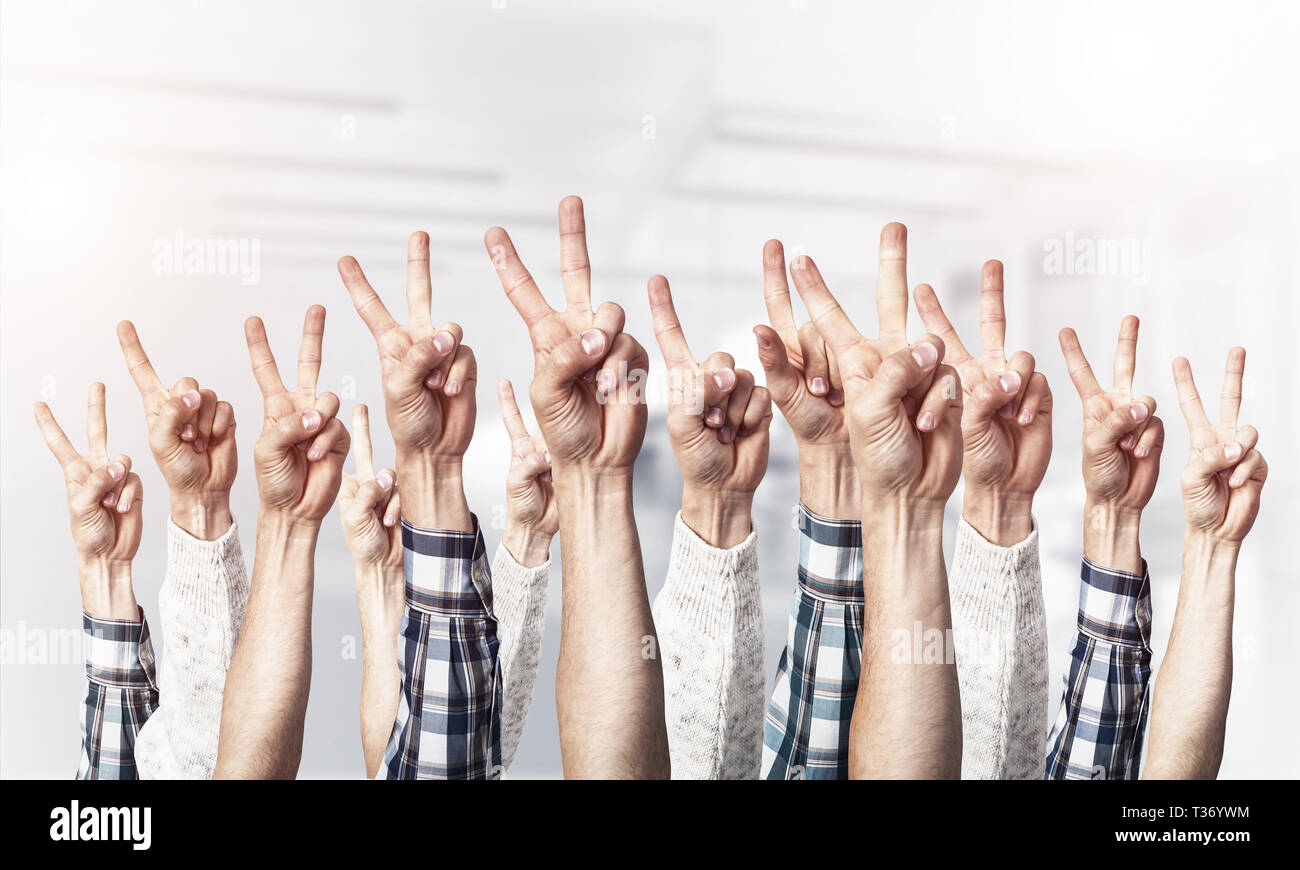 Row of man hands showing victory gesture. Winning or triumph group of ...