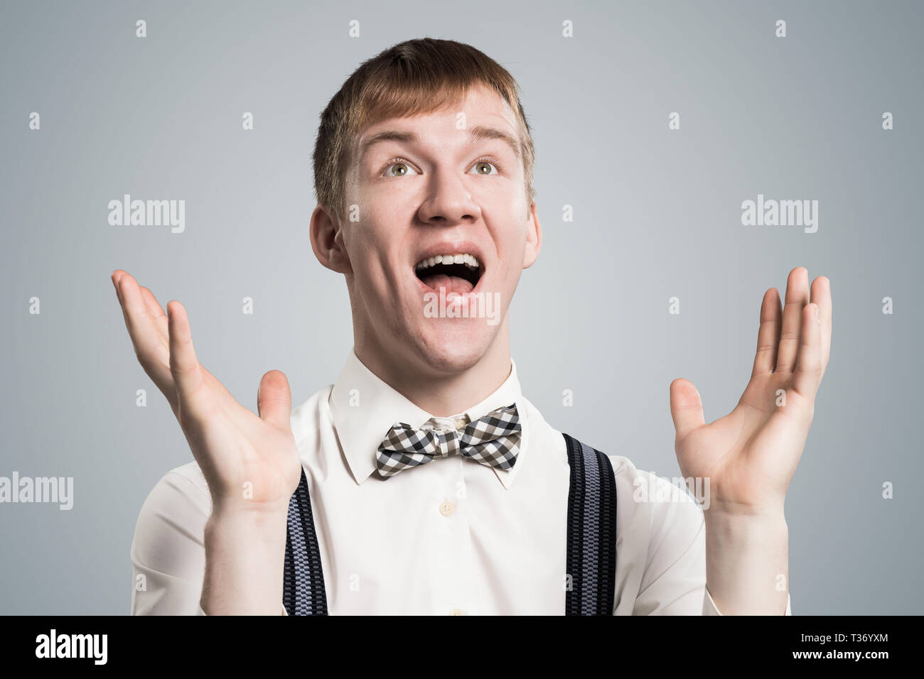 Friendly hipster smiling broadly with satisfied and pleasant look ...