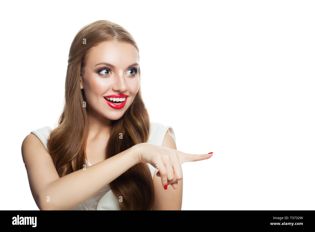 Happy surprised woman model pointing finger isolated on white, portrait ...