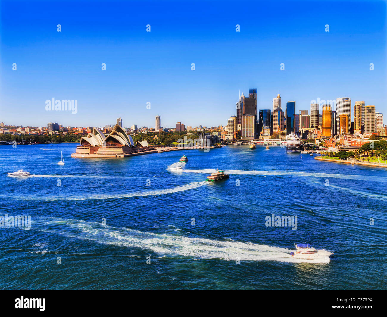 Heavy maritime boat traffic on Sydney harbour in view of major city CBD ...