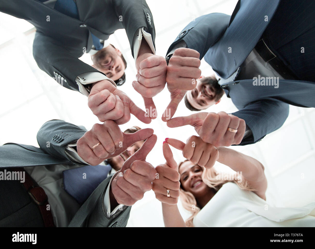 close up.business team showing their unity Stock Photo - Alamy