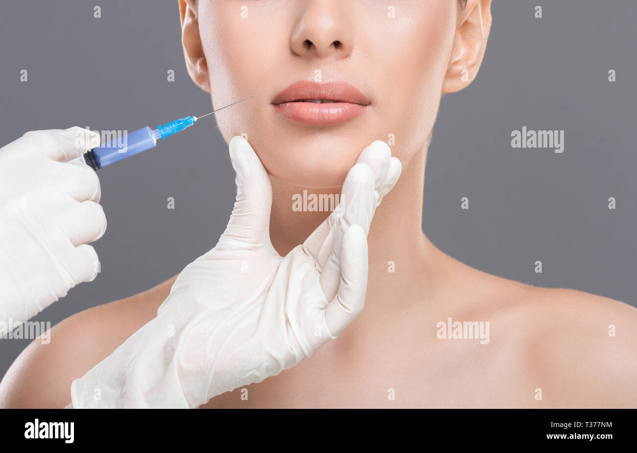 Young woman receiving facial skin lifting injections Stock Photo - Alamy