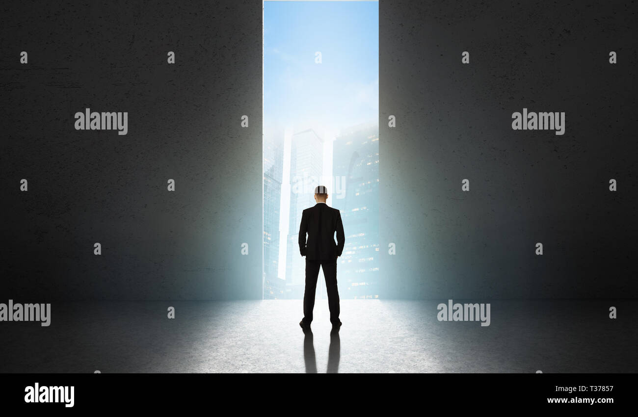 Silhouette of man against giant open door. Business opportunities ...