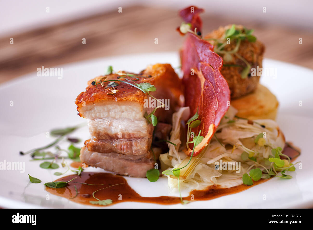 Close up shot of Pork belly & crispy bacon with crackling on a white ...