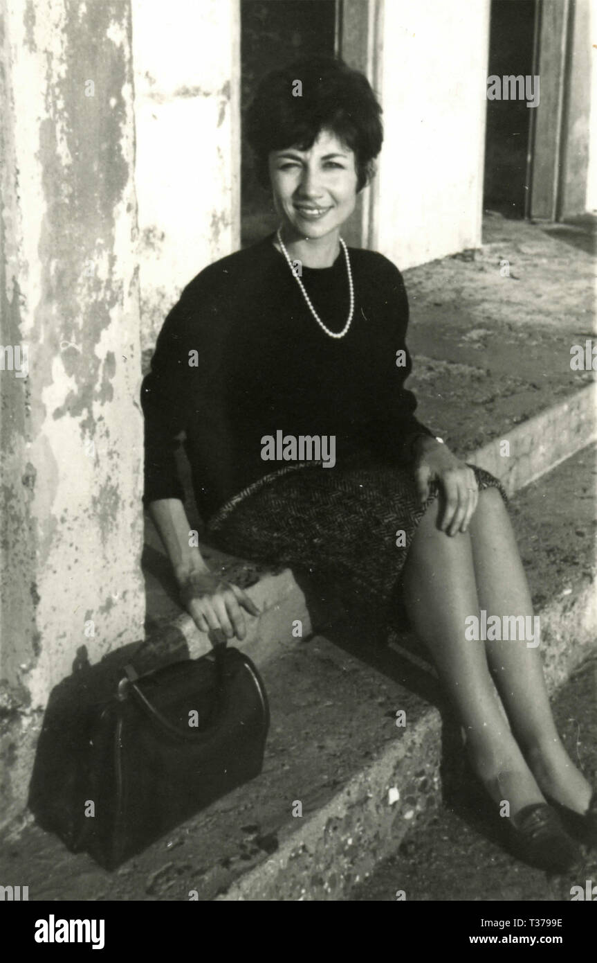 Woman sitting on the steps, Italy 1960s Stock Photo - Alamy