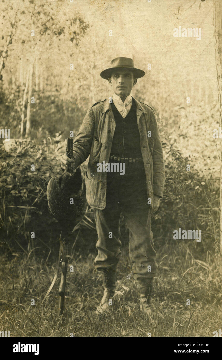 Hunter posing with his pray and rifle, Italy 1900s Stock Photo - Alamy