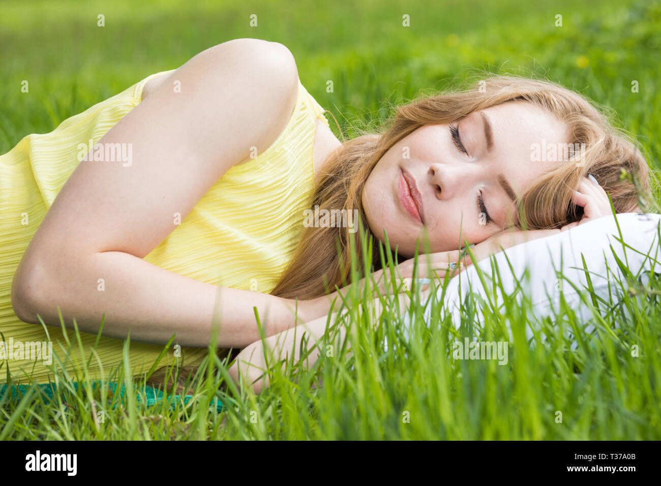 Rest and relaxation concept . Woman sleeping on pillow on grass ...