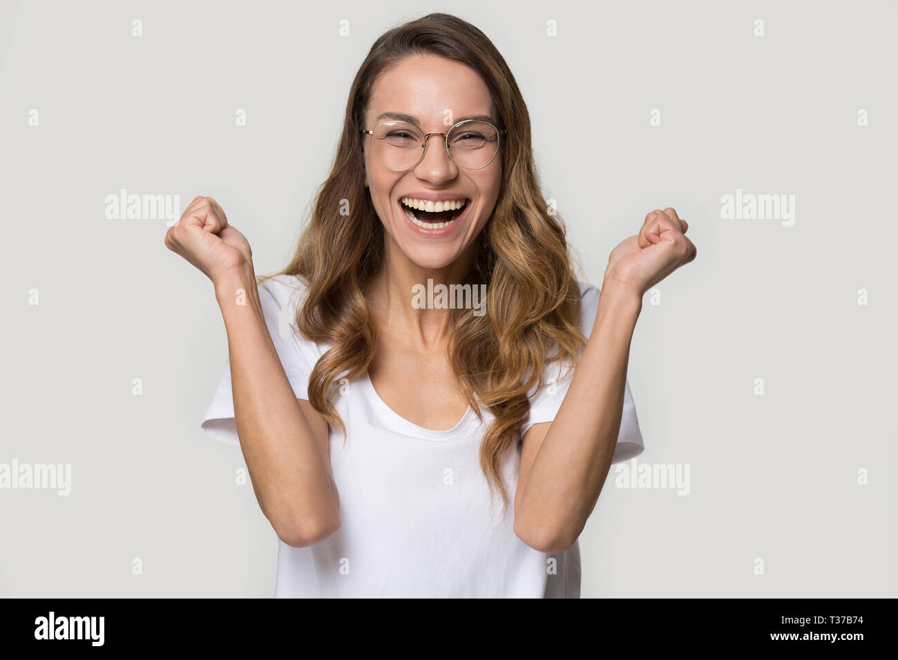 Overjoyed woman feels happy celebrating victory and reached goal Stock ...