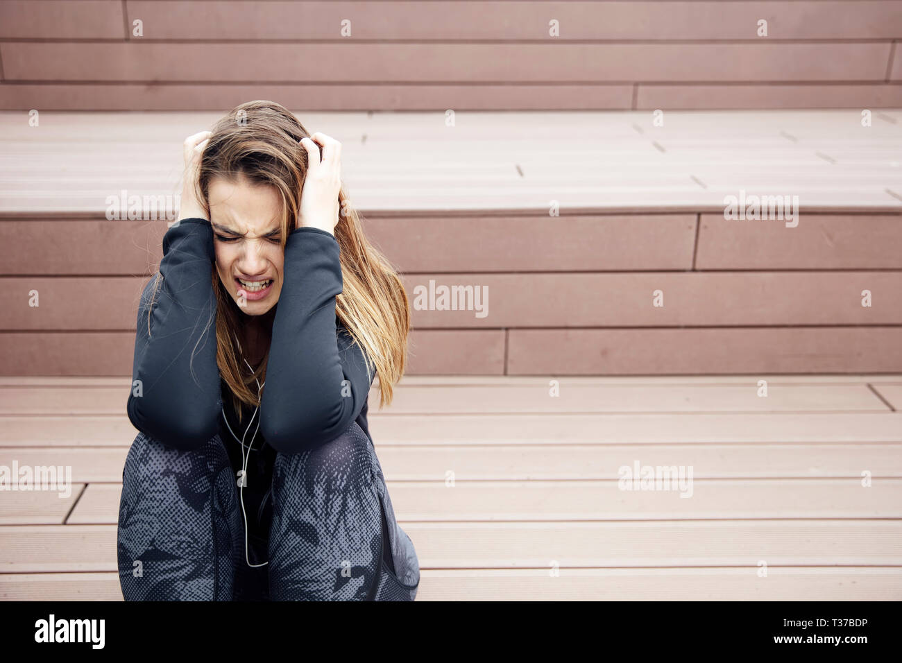 Portrait of angry sad young woman sitting outdoor Stock Photo - Alamy