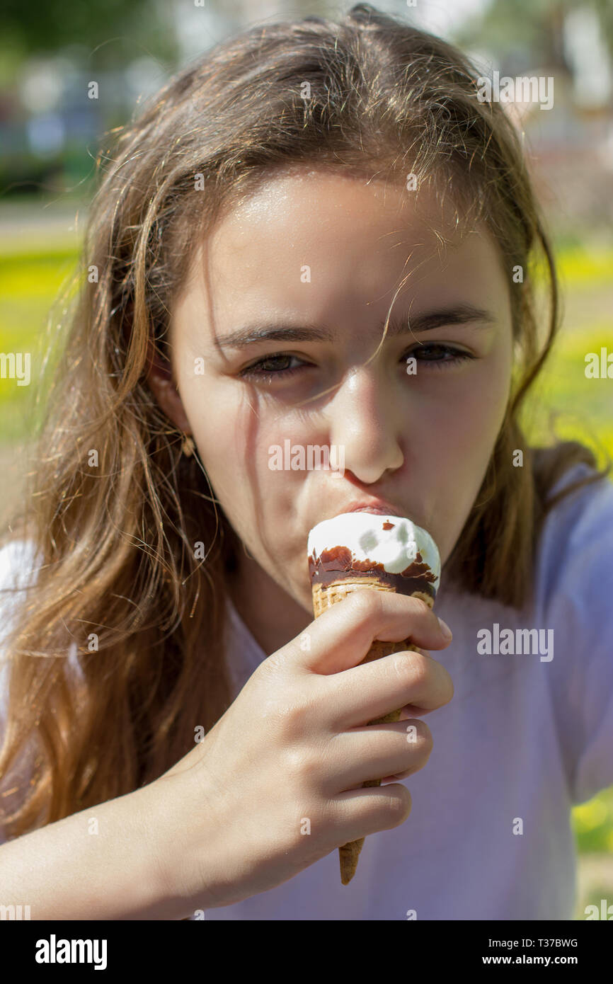 Beautiful Teen Girl Eating Ice Cream In Waffle Cone In Summer Stock