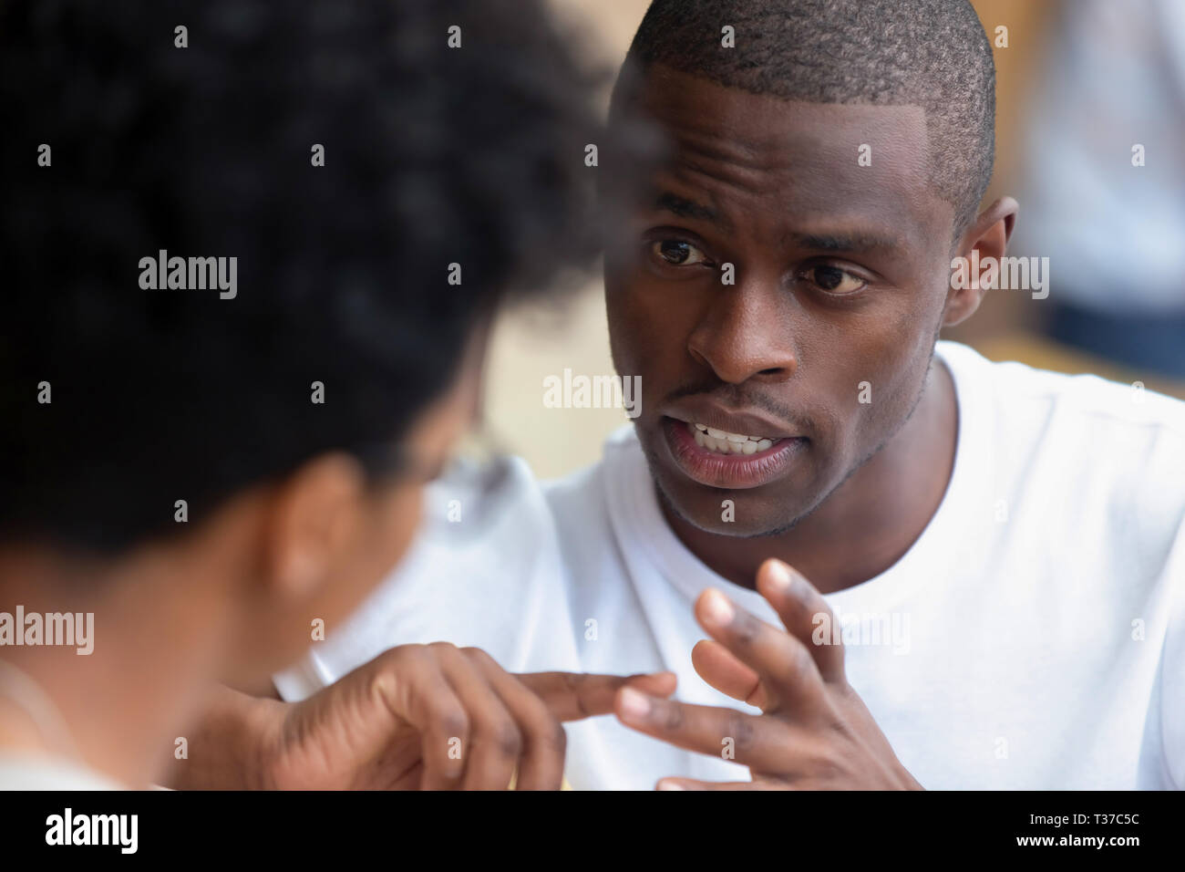 Focused african man having serious talk with woman at meeting Stock ...