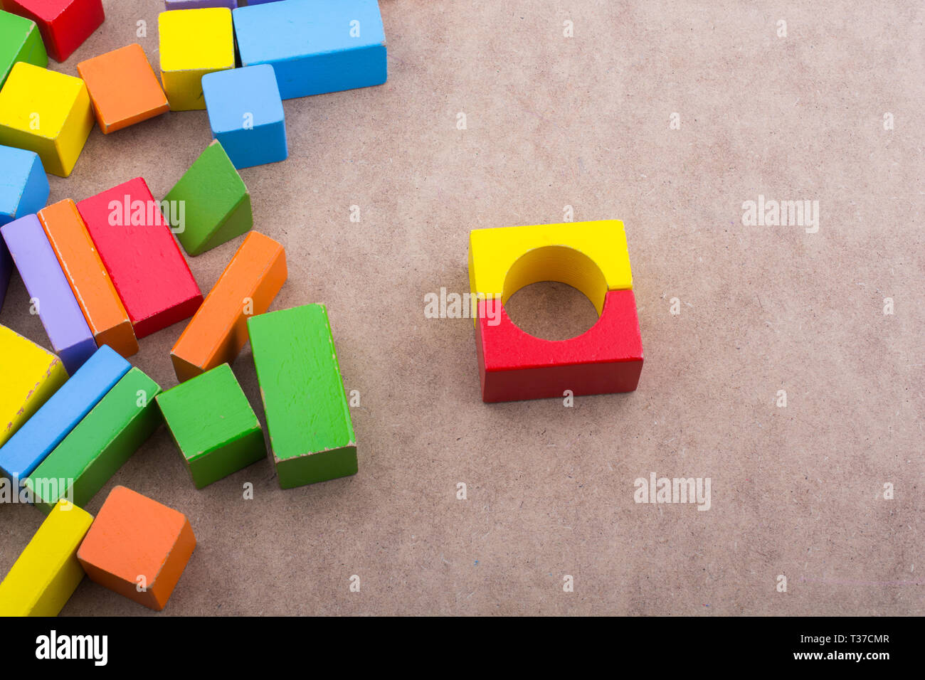 Colorful building blocks on a brown background Stock Photo - Alamy