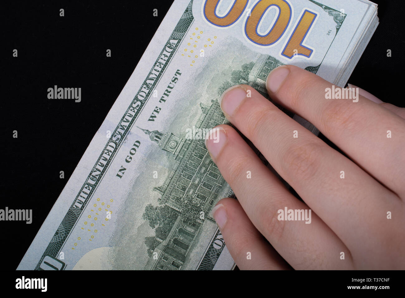 Hand holding American dollar banknotes isolated on white background ...