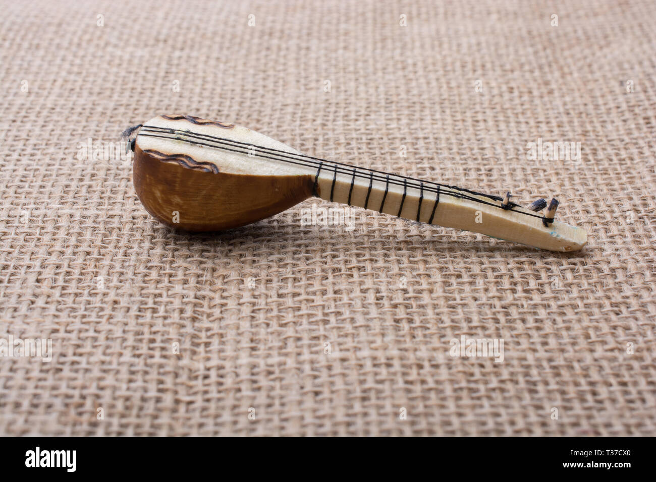 Model of Turkish musical instrument saz on a linen canvas Stock Photo ...