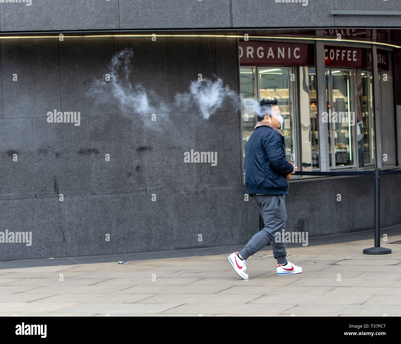 Man Vaping in the street Stock Photo - Alamy
