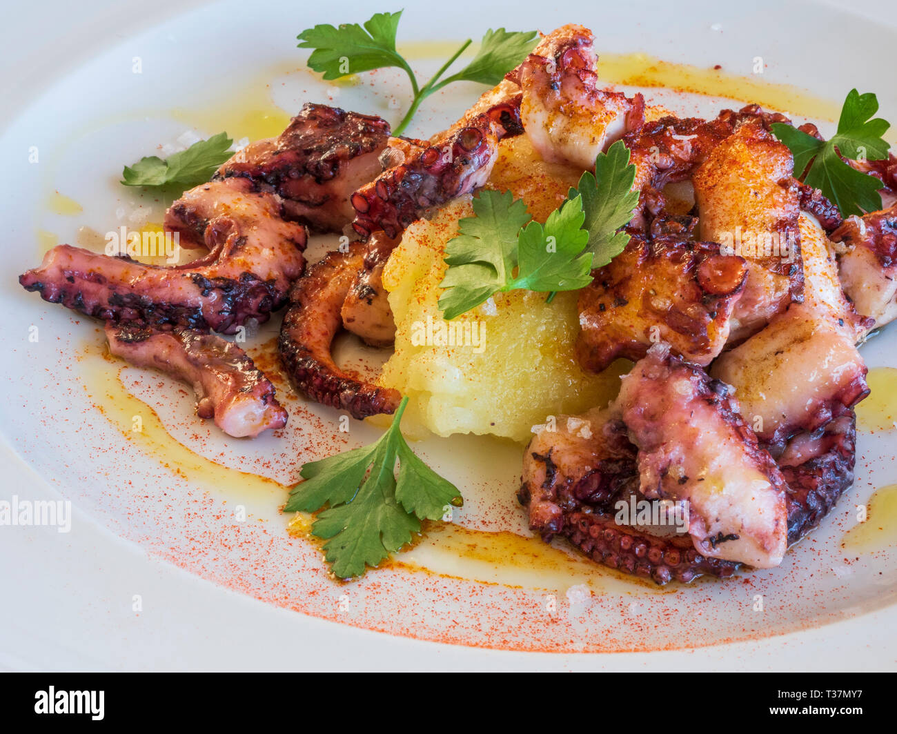 grilled octopus with potatoes Stock Photo - Alamy