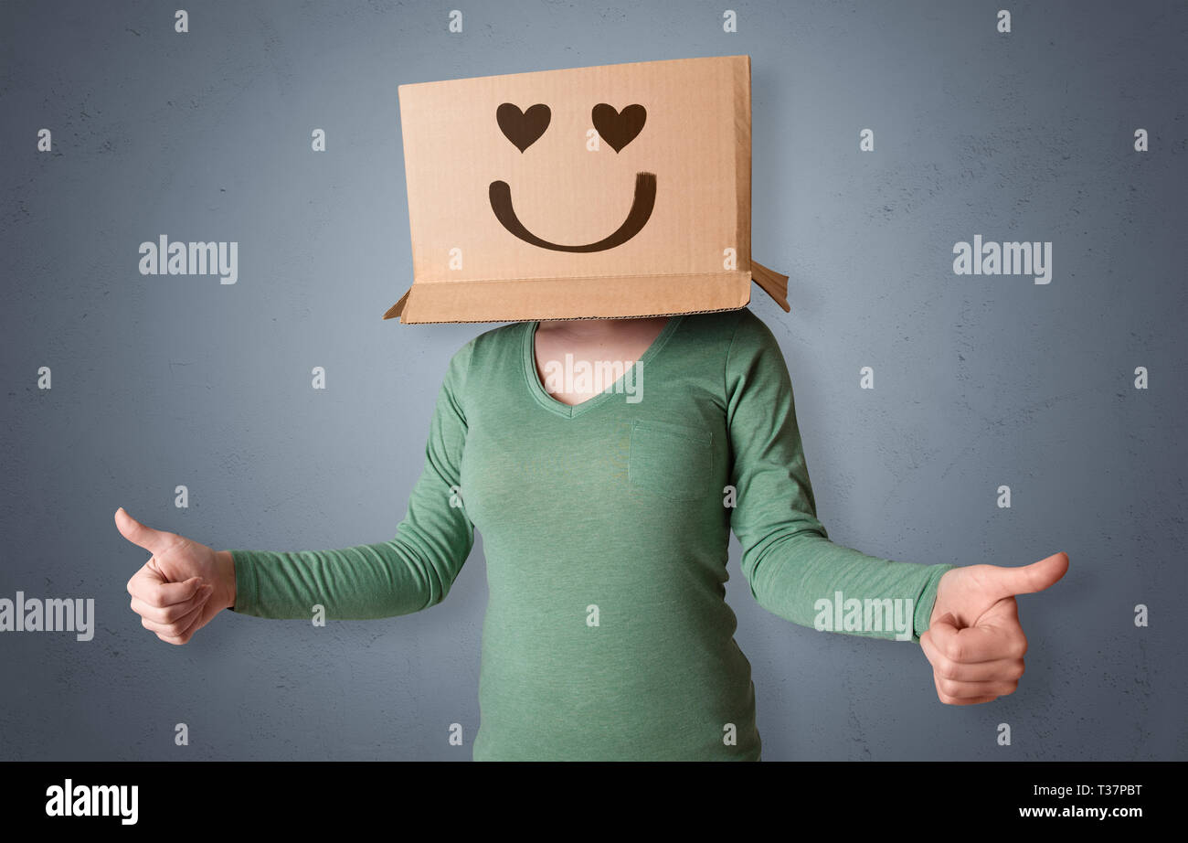 Funny woman wearing cardboard box on her head with smiley face Stock ...