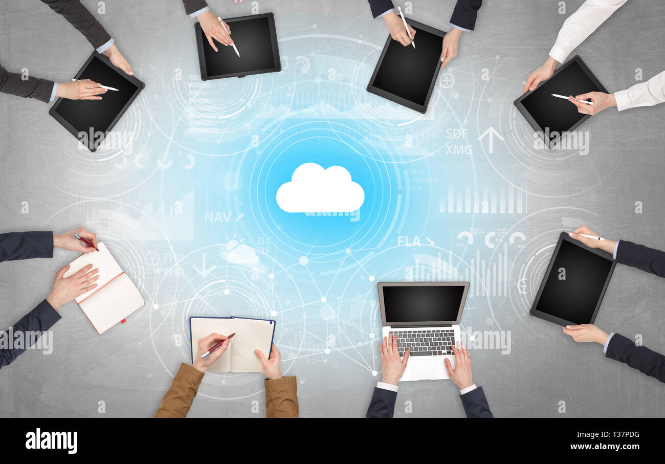 Group of people with devices in hands working on reports with online ...