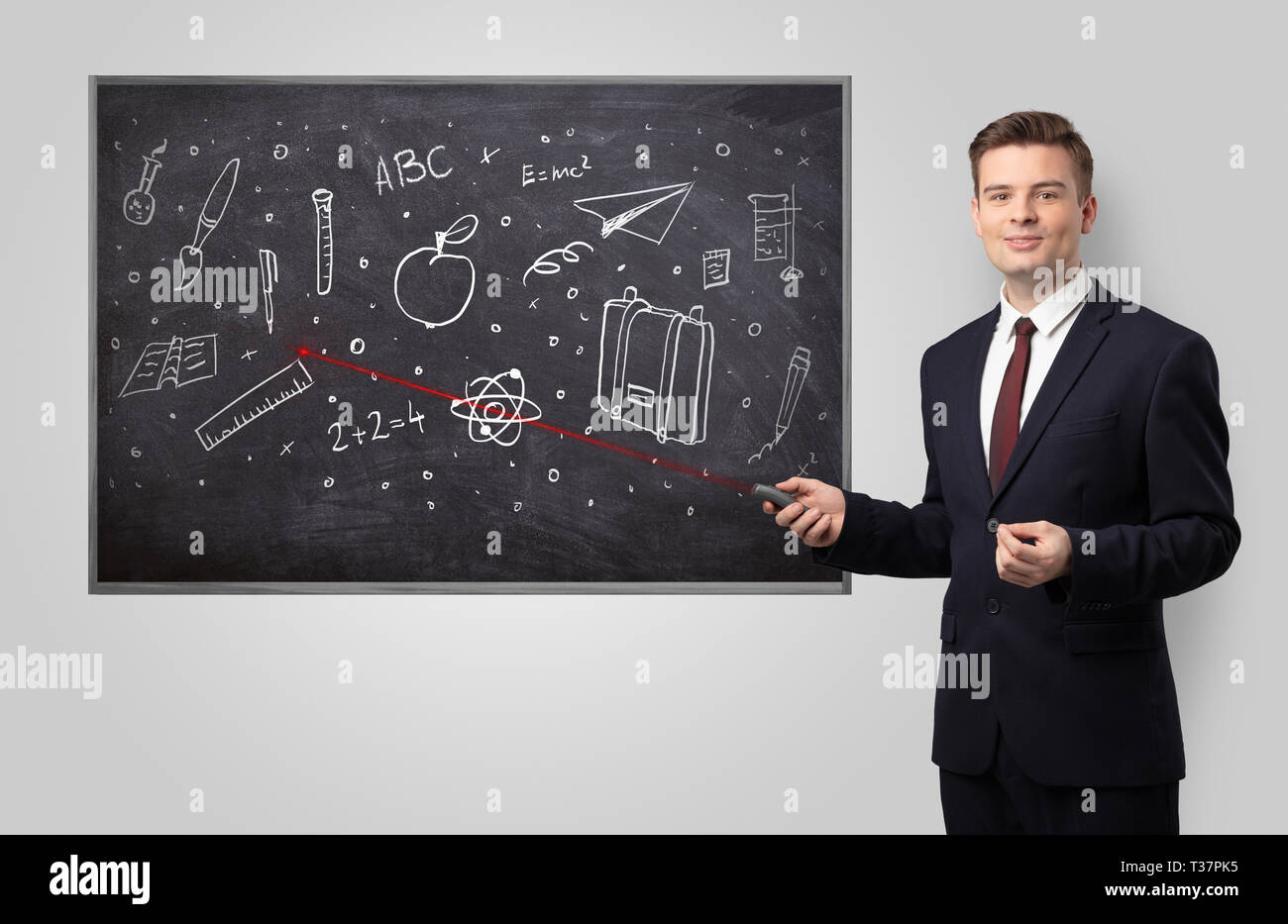 Handsome young teacher with laser pointer teaching Stock Photo - Alamy