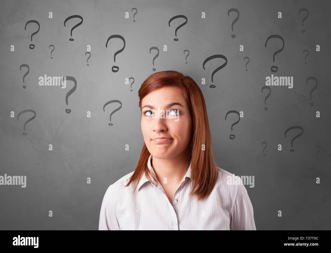 Person with question marks around face Stock Photo - Alamy