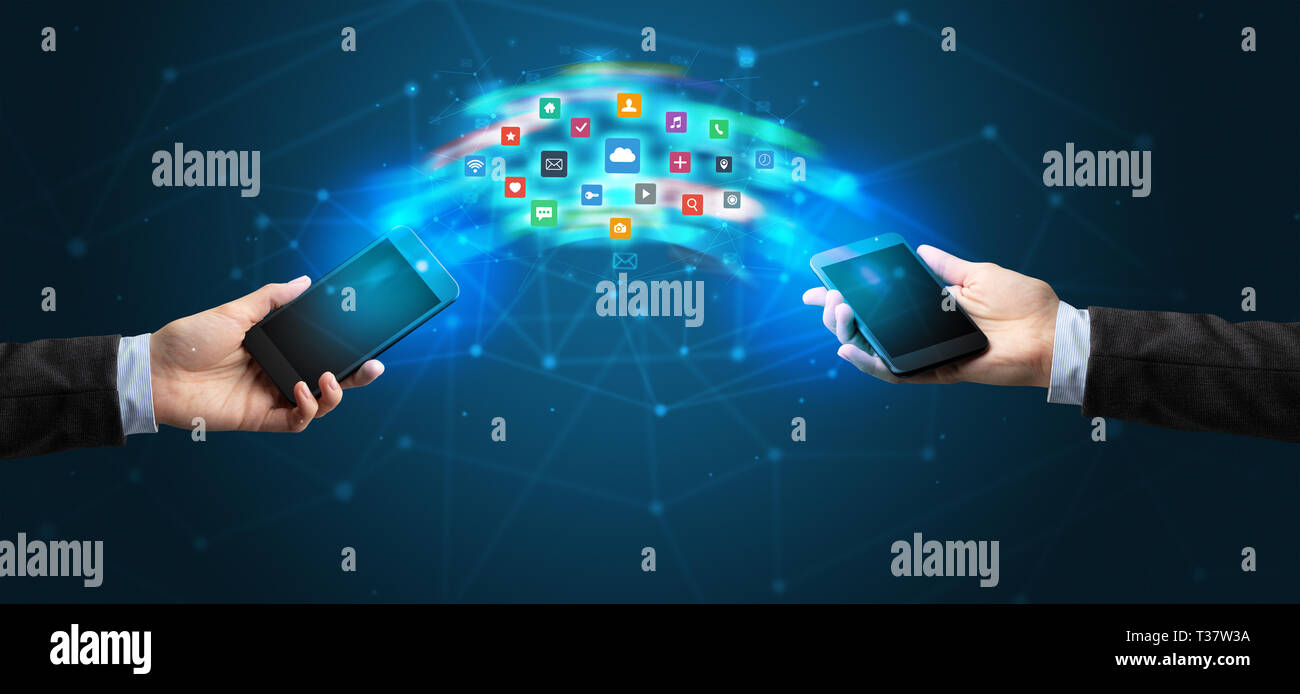 Two mobile phones syncing applications concept Stock Photo - Alamy